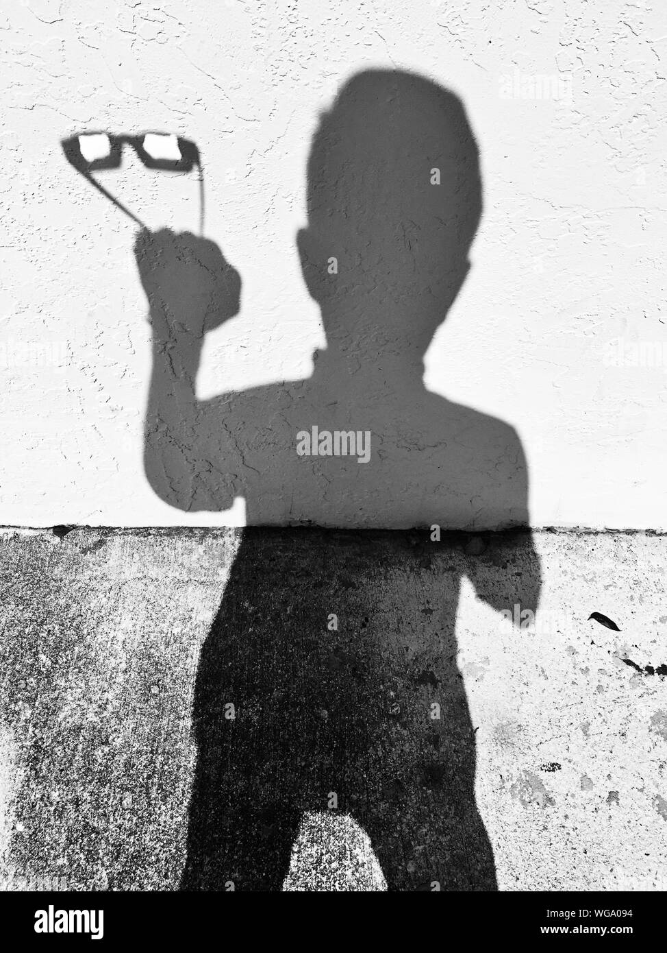 Boy wall standing shadow hi-res stock photography and images - Alamy