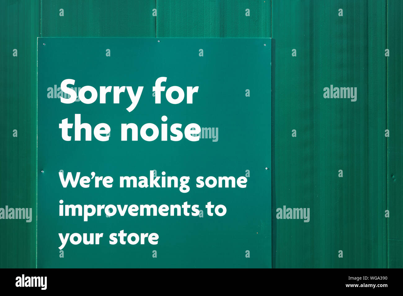 Sorry for noise sign at construction building site Stock Photo - Alamy