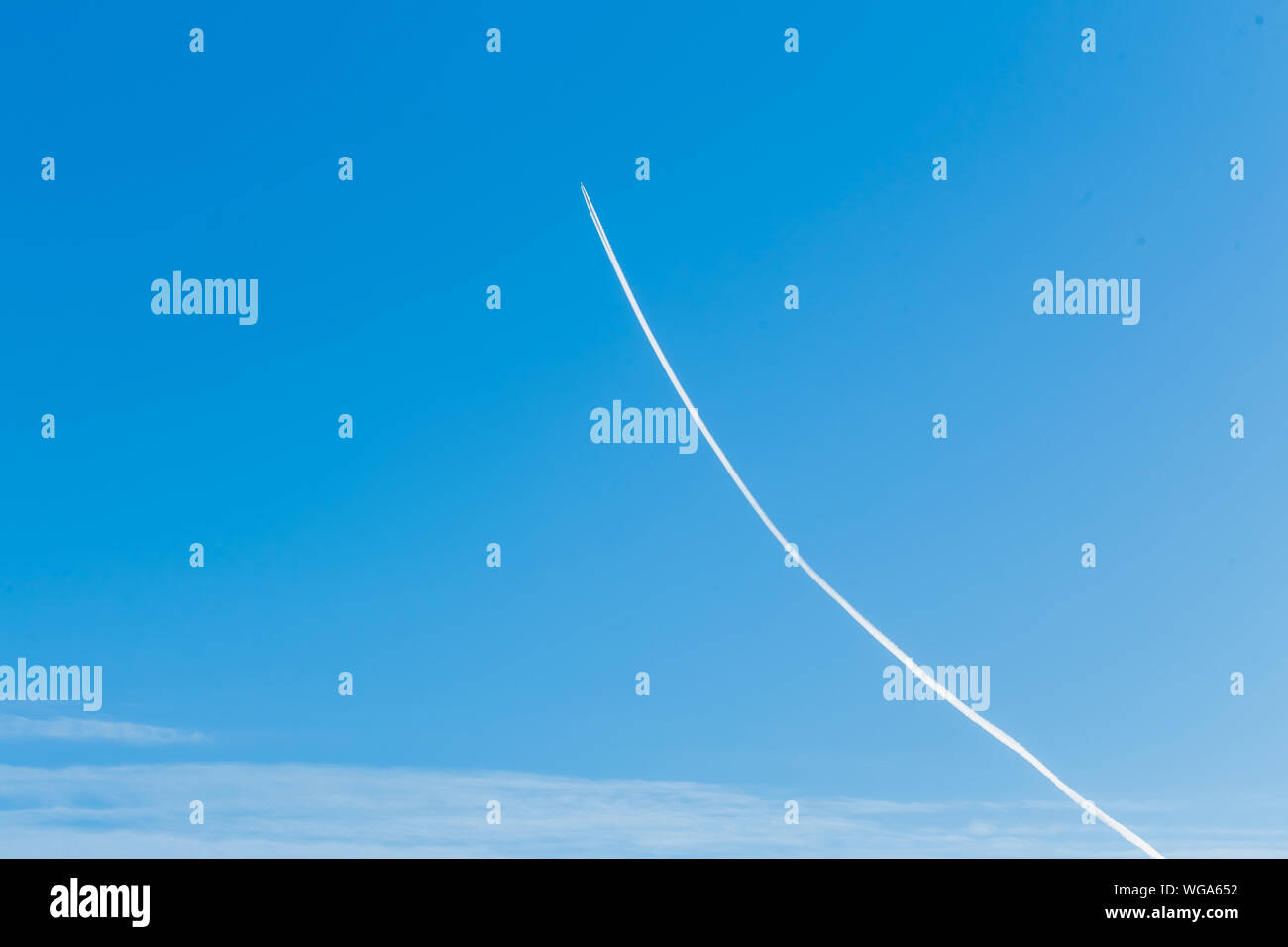 One long trace of the airplane on the blue sky in summer Stock Photo ...