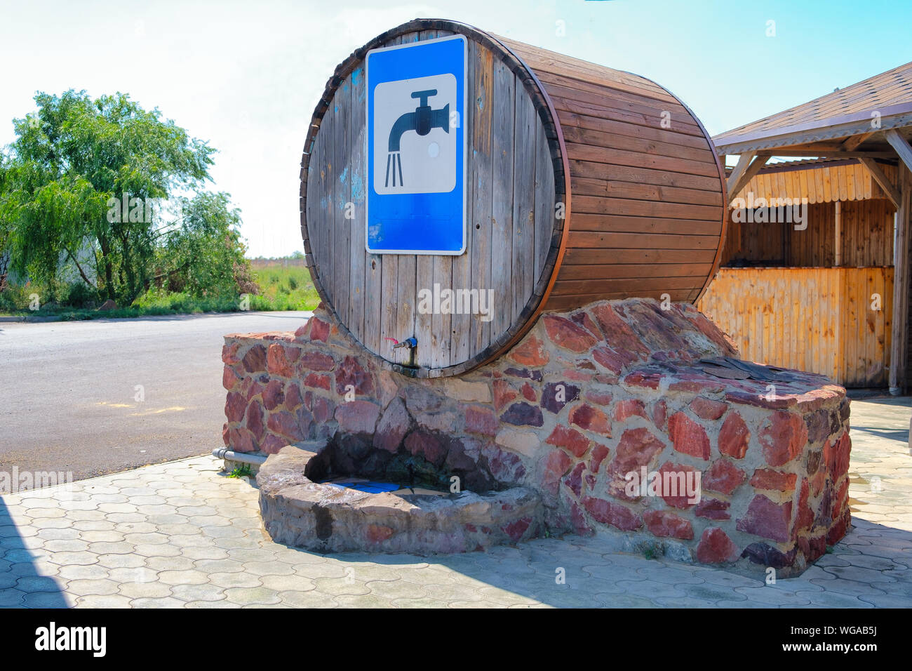 Wooden barrel with drinking water. The barrel is mounted on a stone ...