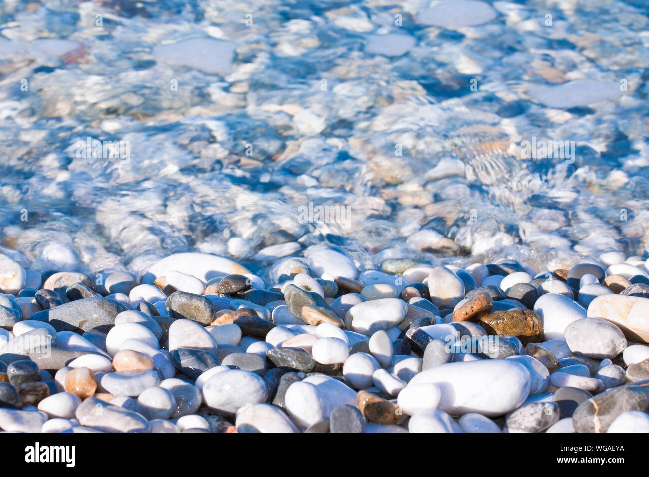Rounded white stones under fresh transparent water Stock Photo - Alamy