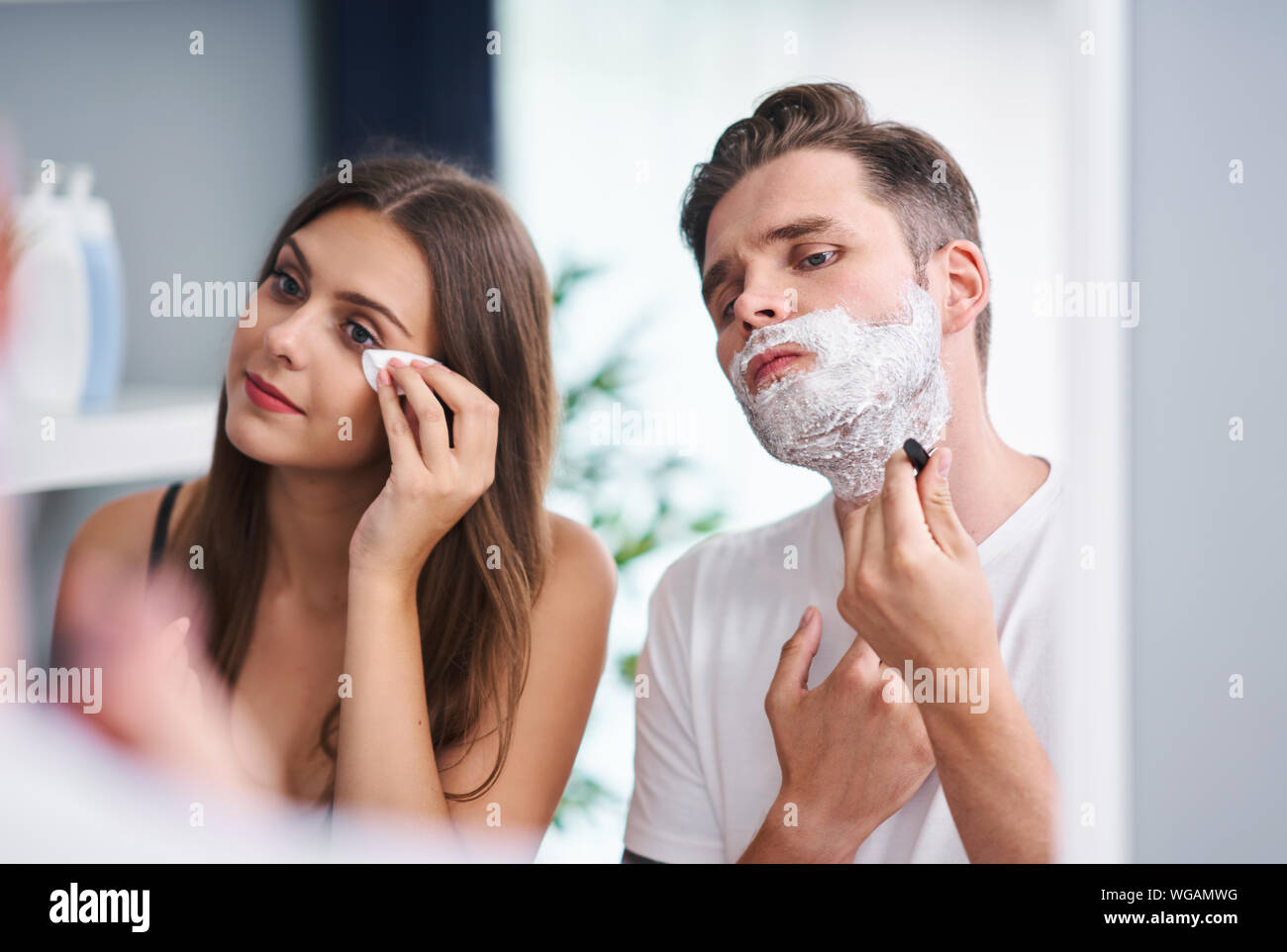 Happy young couple in the bathroom Stock Photo - Alamy