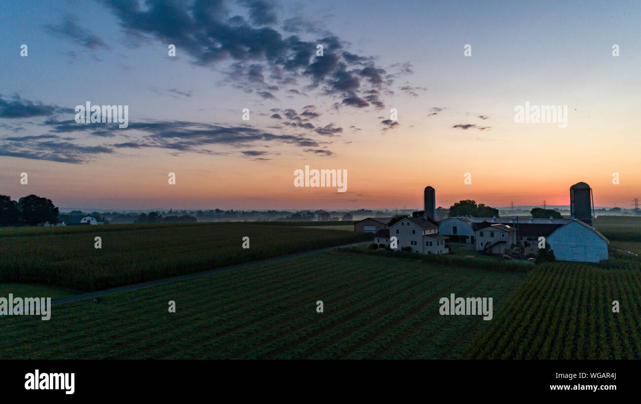 An Aerial View of a Sunrise Over an Amish Farm with Blues and Reds on a ...