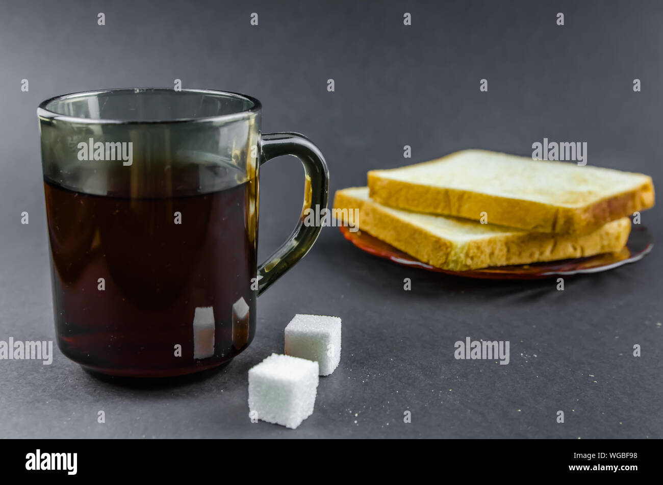 morning tea and toast on a black background Stock Photo - Alamy