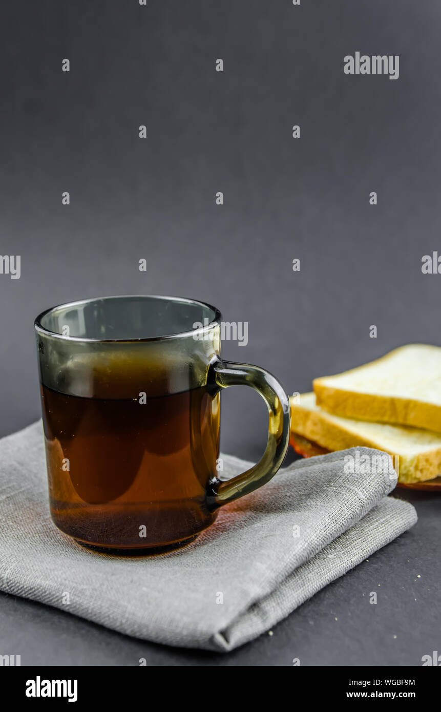 morning tea and toast on a black background Stock Photo - Alamy