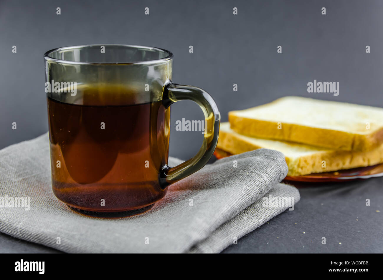 morning tea and toast on a black background Stock Photo - Alamy