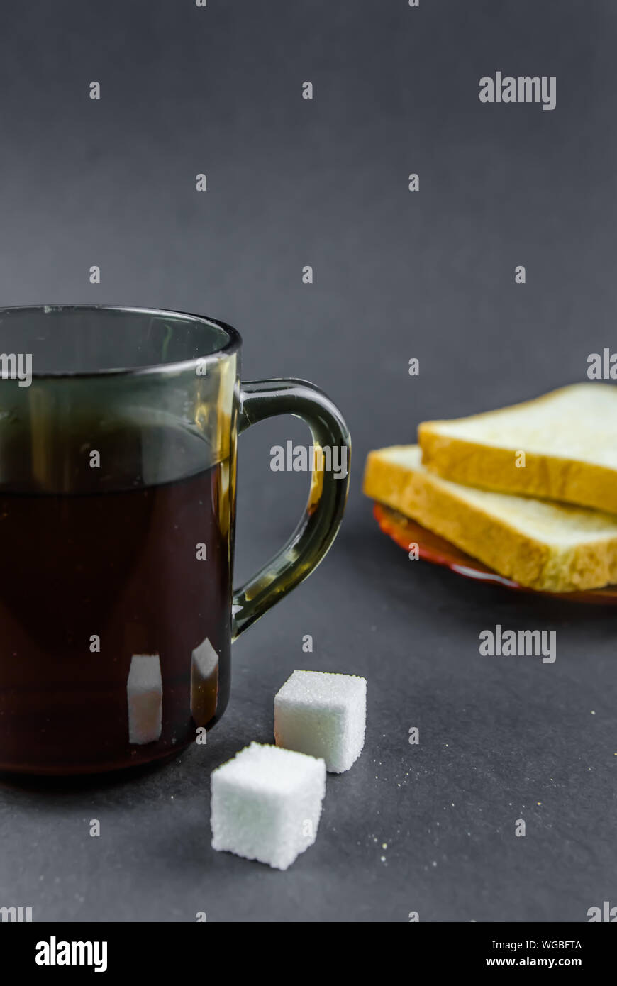 morning tea and toast on a black background Stock Photo - Alamy
