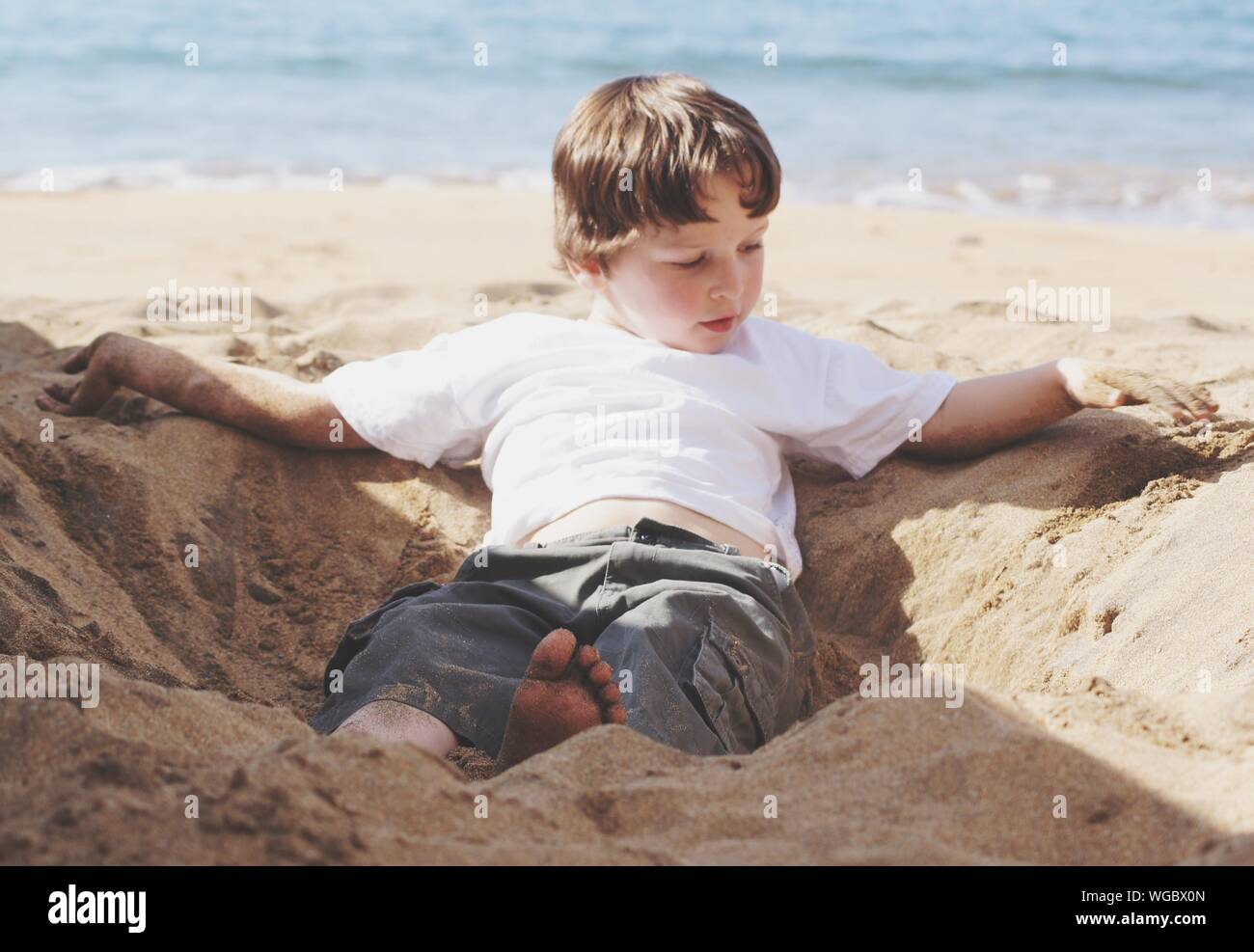 Boy digging sand hi-res stock photography and images - Alamy