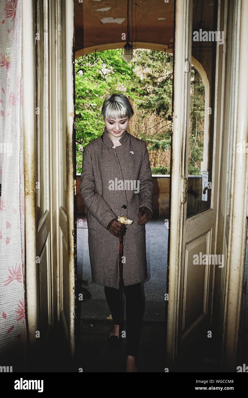 Woman walking through door hi-res stock photography and images - Alamy