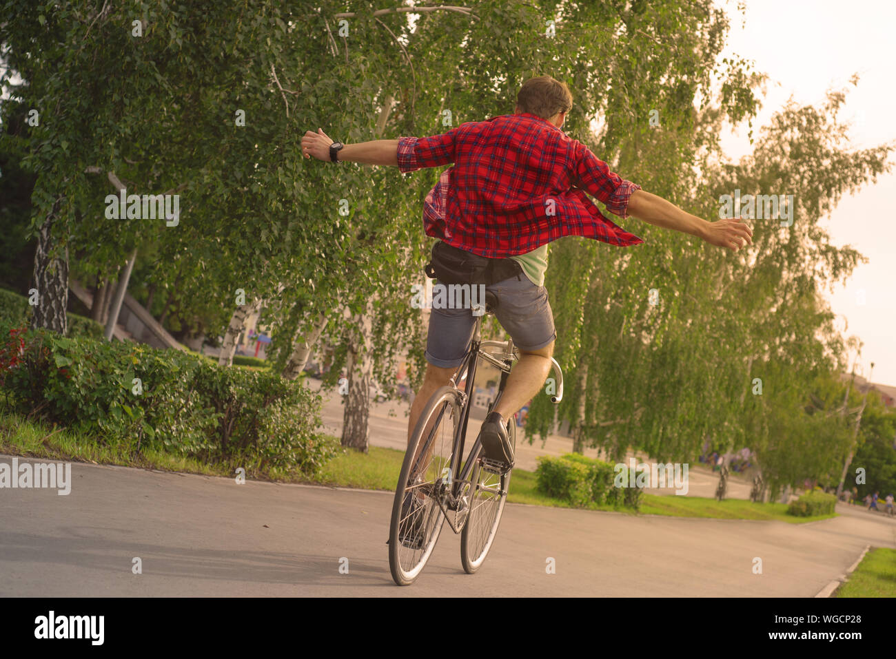 Summer freedom. Biker ride away with no hands Stock Photo - Alamy