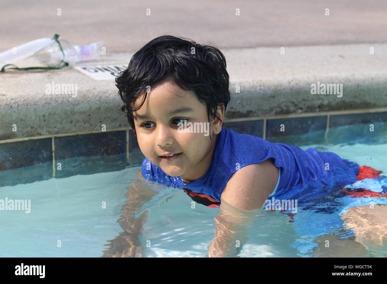 Person sitting by the pool hi-res stock photography and images - Alamy