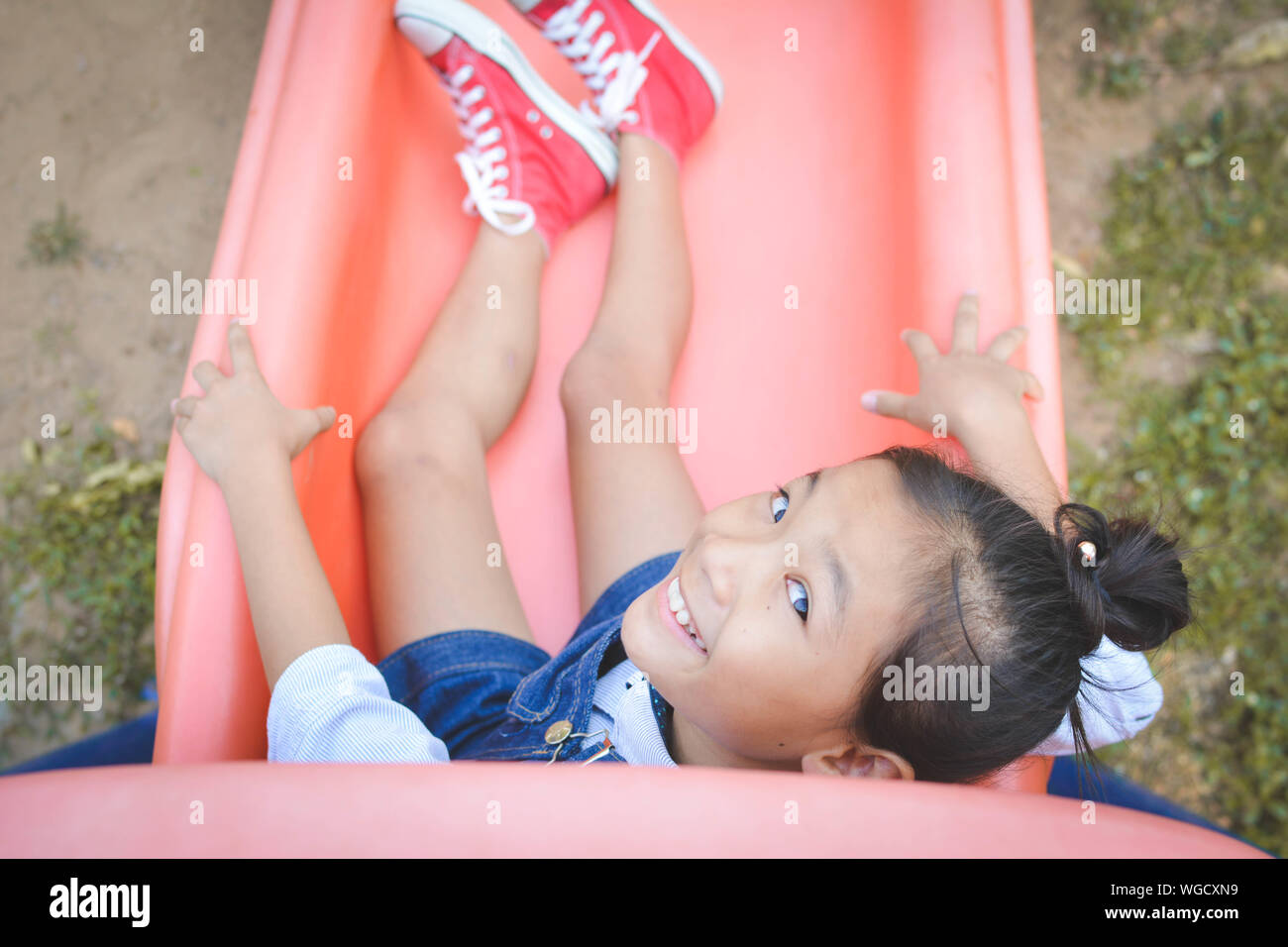 Girl playing slide hi-res stock photography and images - Alamy