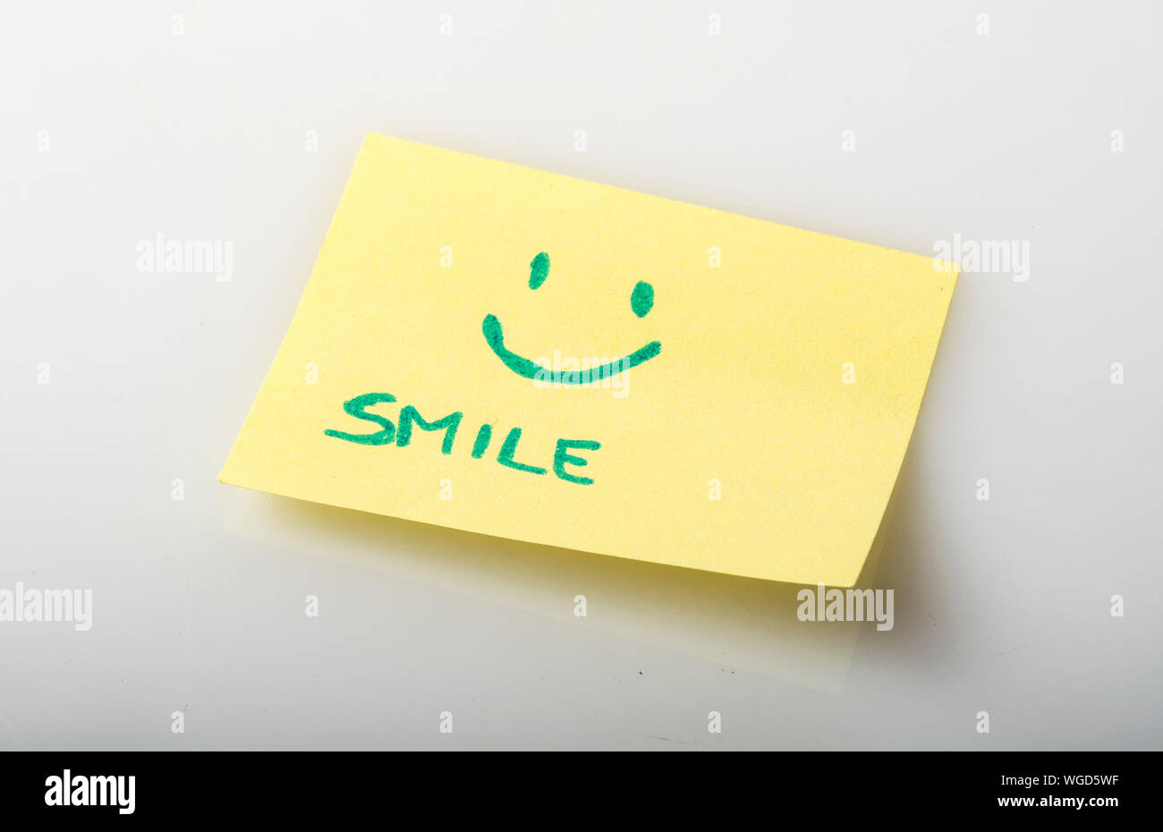 Close-up Of Smiley Face On Adhesive Note Against White Background Stock ...