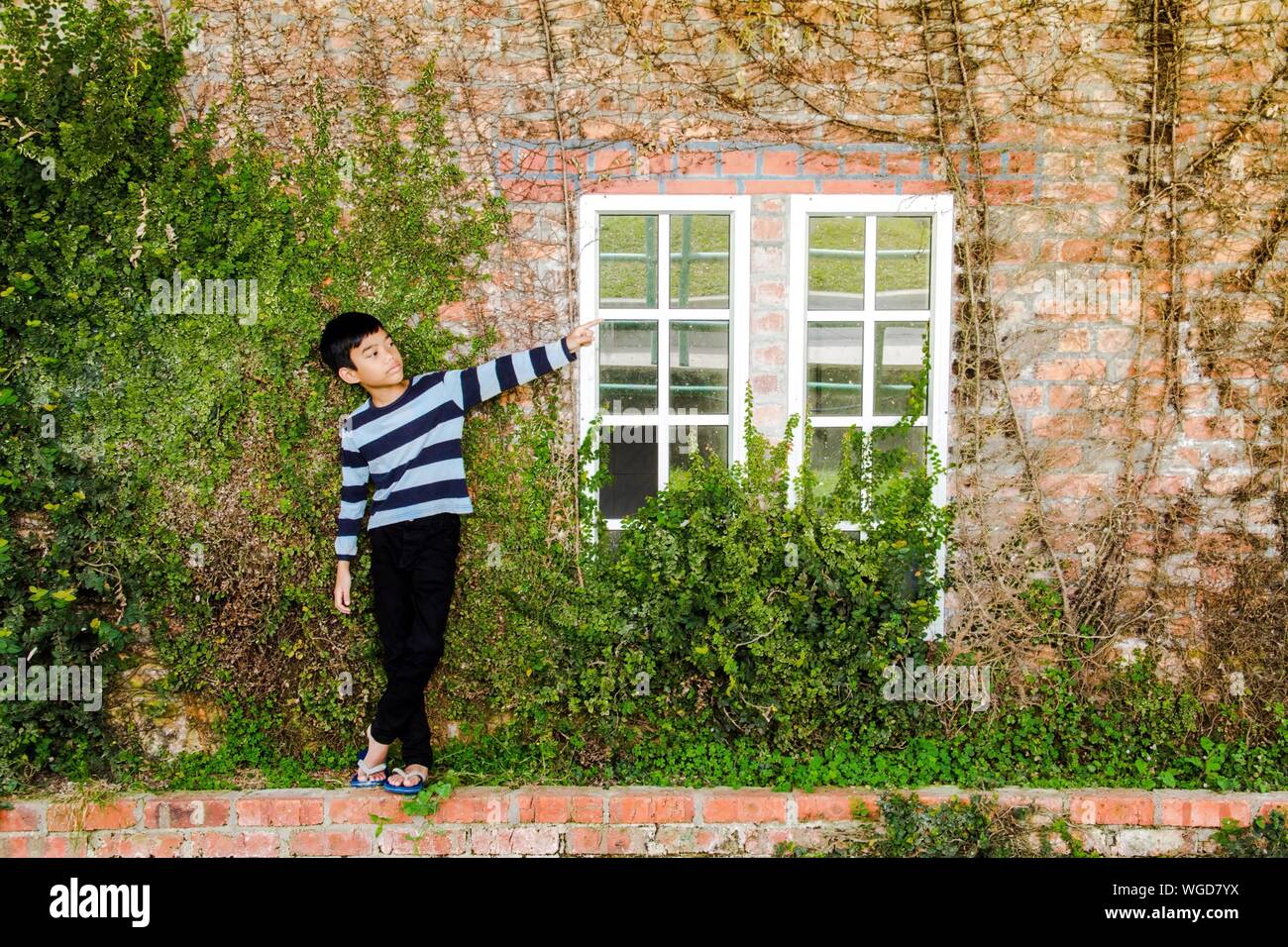 Boy standing outside house hi-res stock photography and images - Alamy