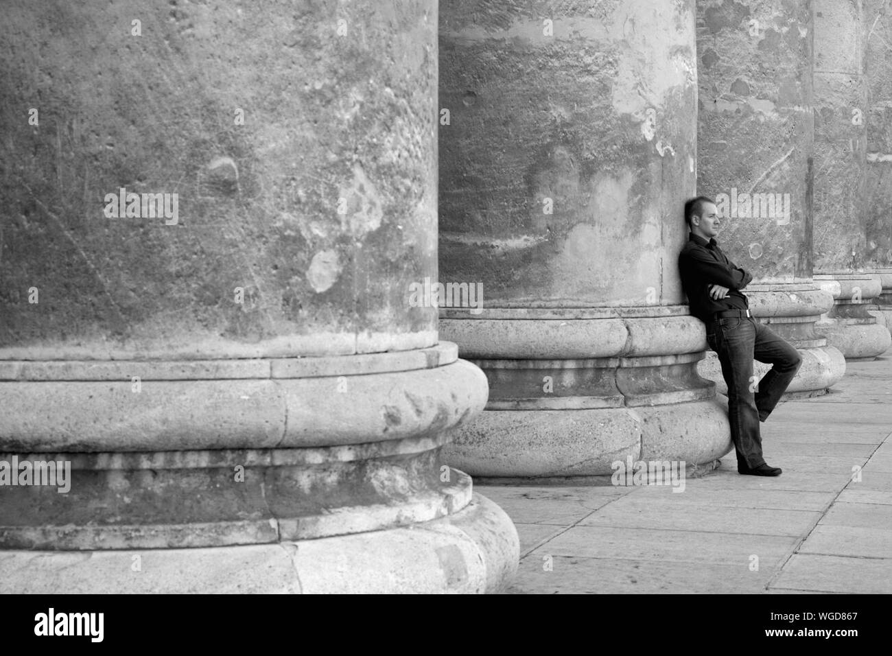 Young man leaning on column hi-res stock photography and images - Alamy