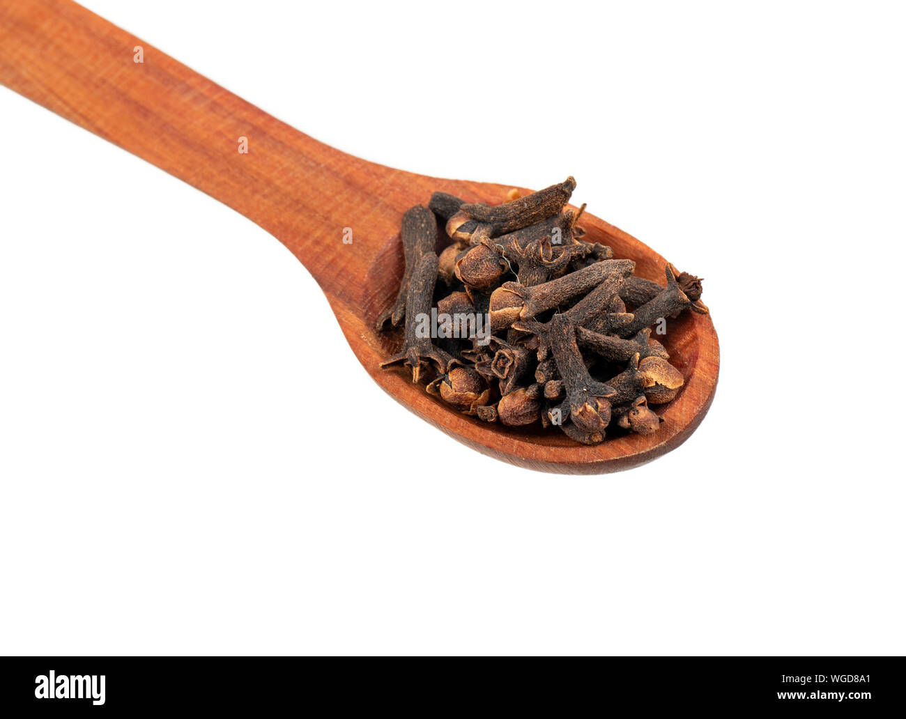 Dry cloves in wooden spoon isolated on white background closeup Stock ...