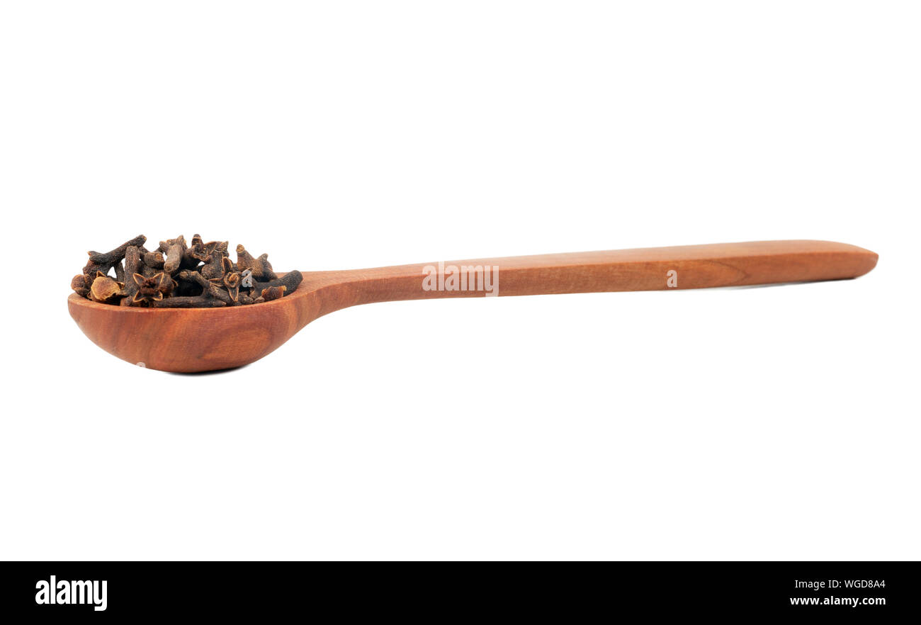 Dry cloves in wooden spoon isolated on white background Stock Photo - Alamy