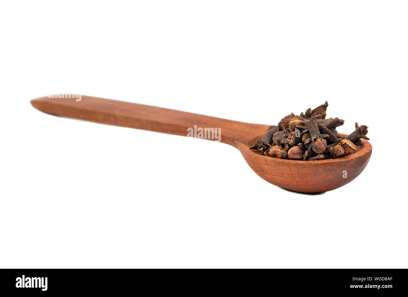 Dry cloves in wooden spoon isolated on white background closeup Stock ...