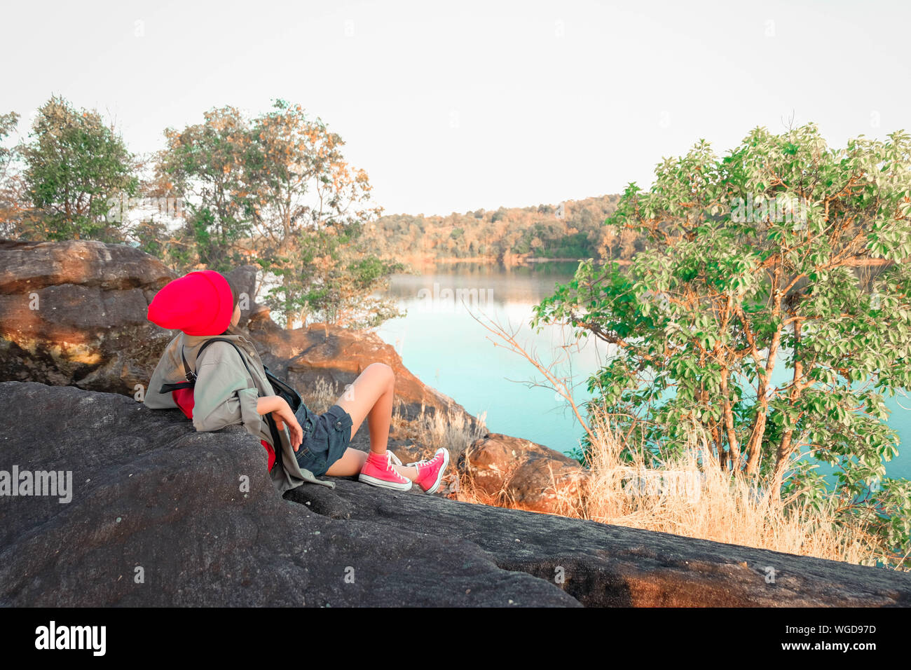Female leaning against rock hi-res stock photography and images - Alamy
