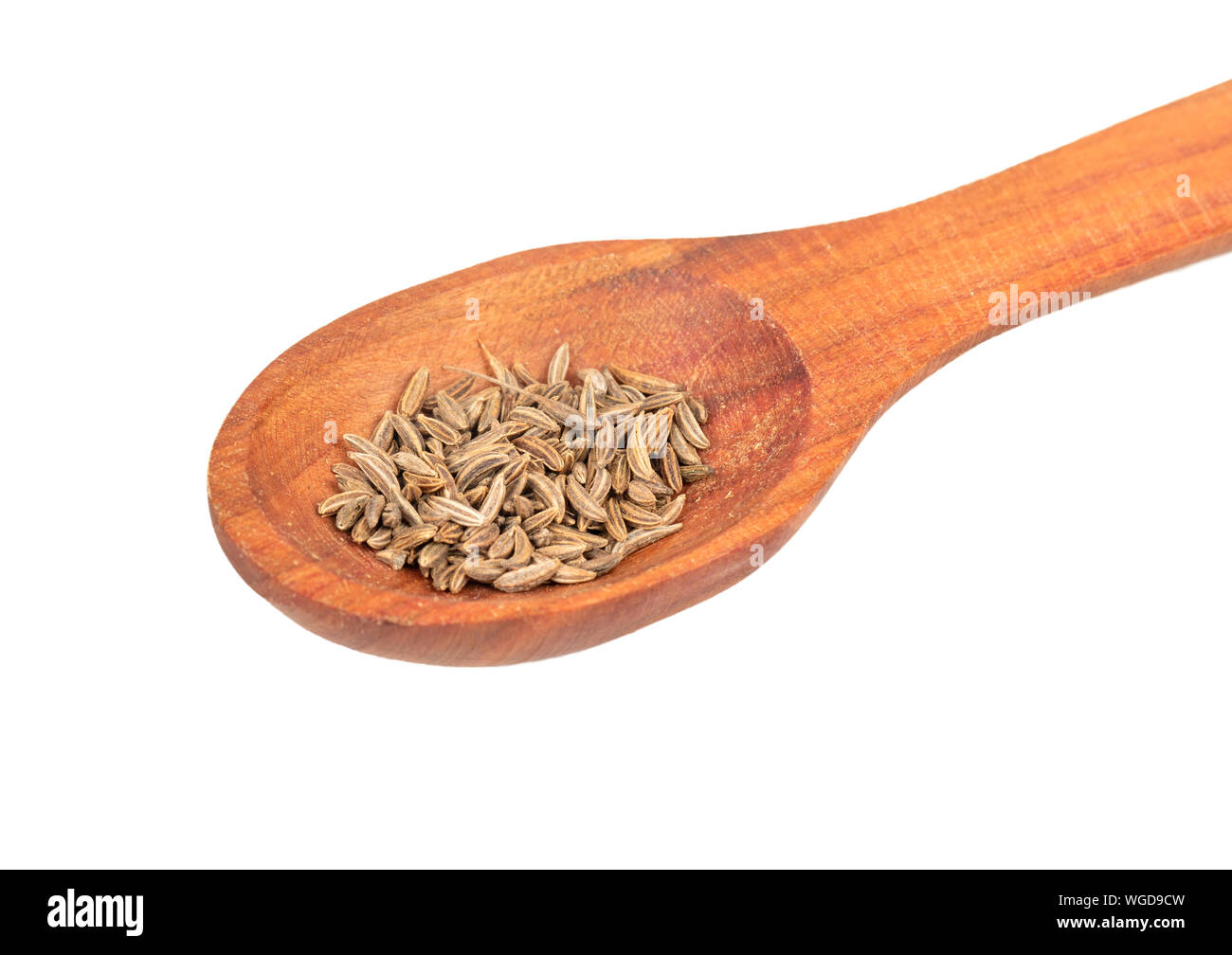 Wooden spoon with dry cumin close-up on white background Stock Photo ...