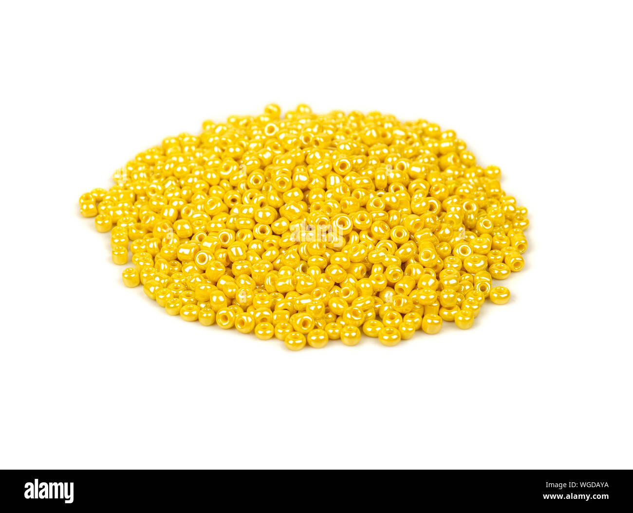 Pile of yellow beads isolated on white background Stock Photo - Alamy