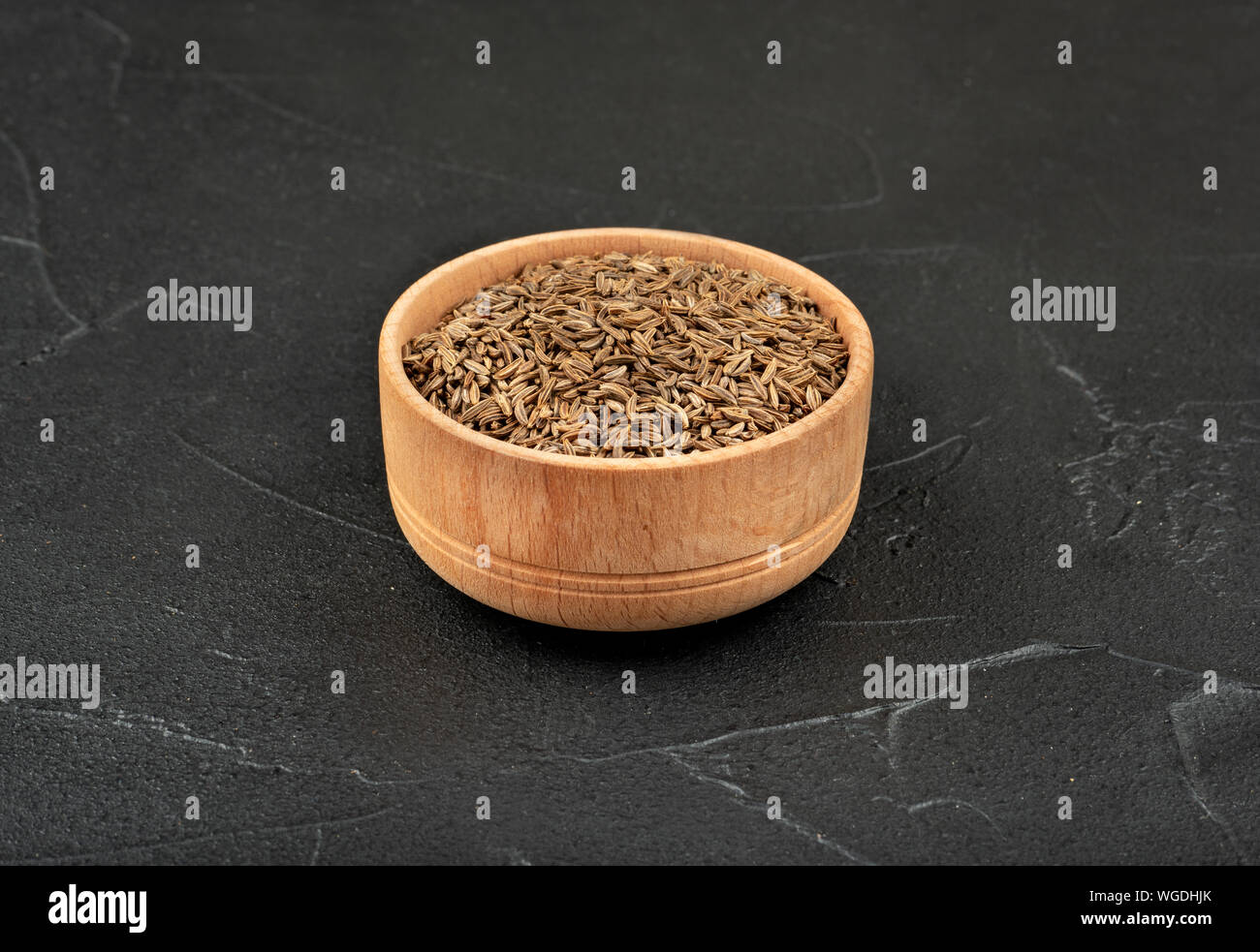 Dry cumin in a wooden bowl on a dark concrete background Stock Photo ...
