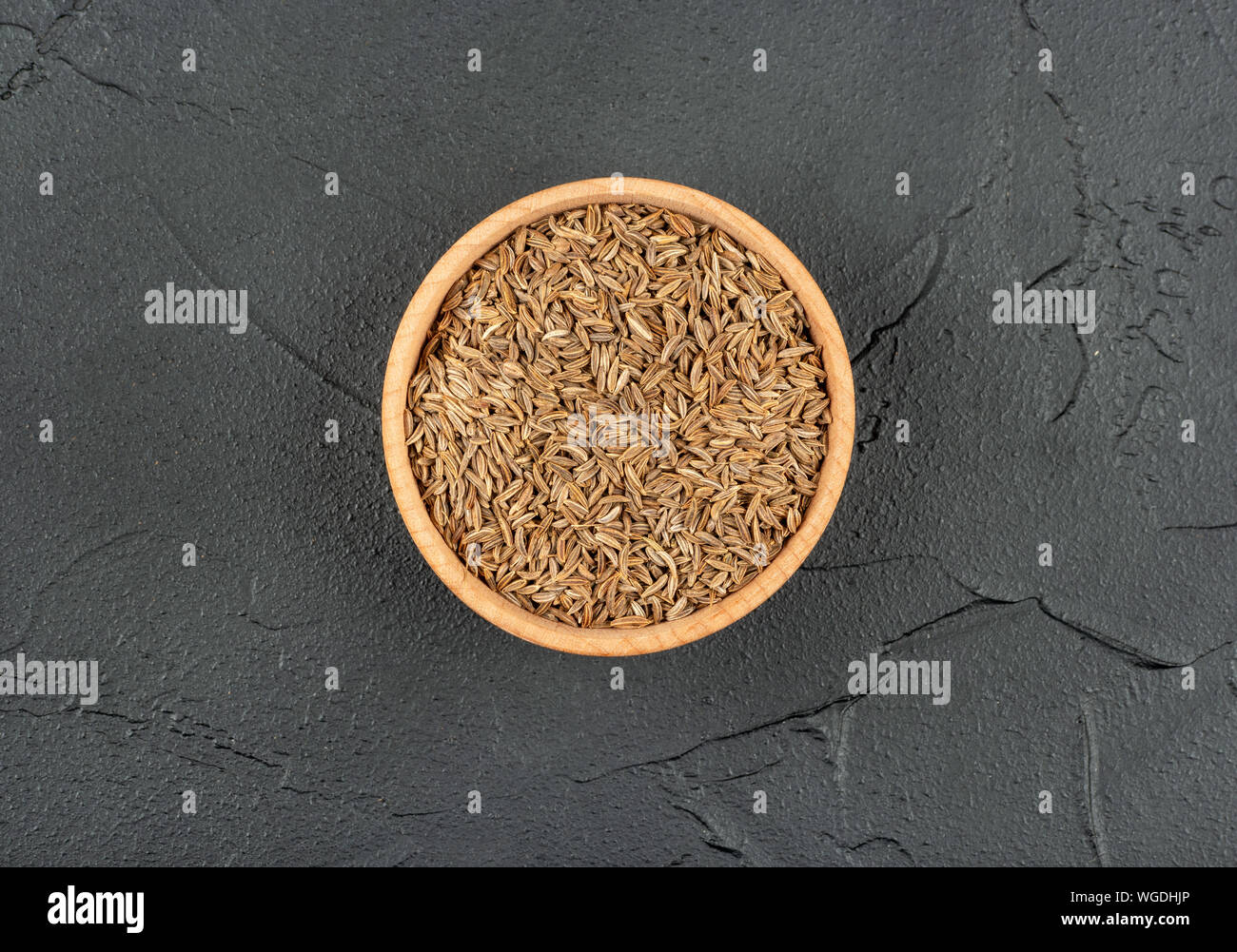 Dry cumin in a wooden bowl on a dark background, top view Stock Photo ...