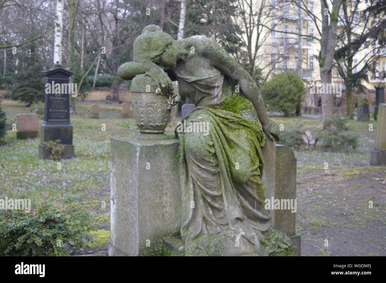 Moss On Statue At Cemetery Stock Photo - Alamy