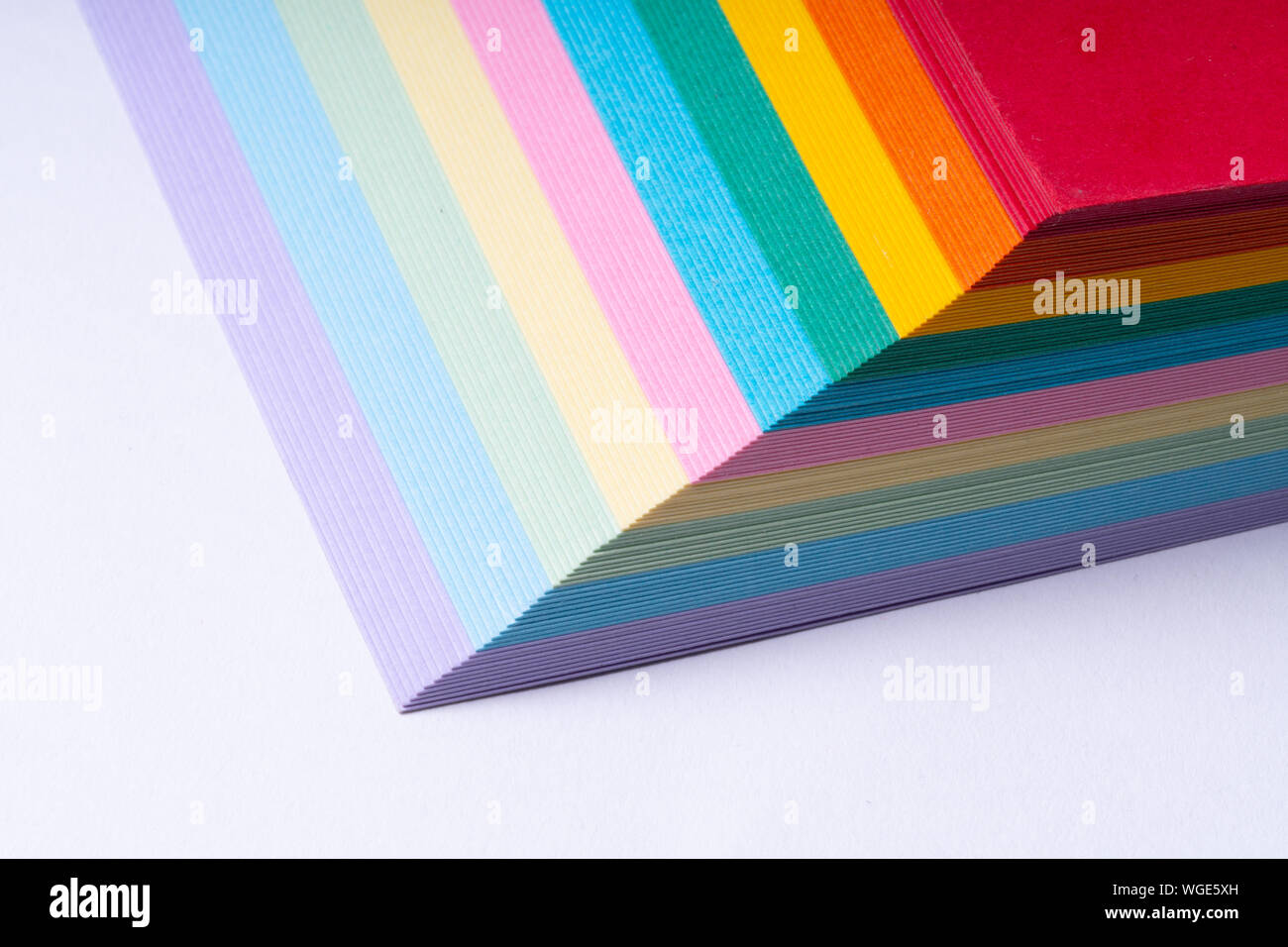 Colored paper stack on white background Stock Photo - Alamy