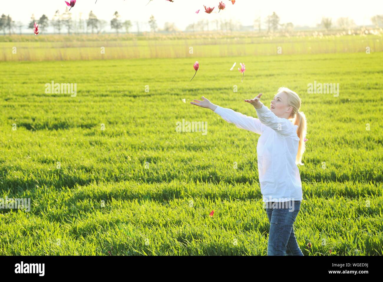 Young woman throwing flowers on hi-res stock photography and images - Alamy