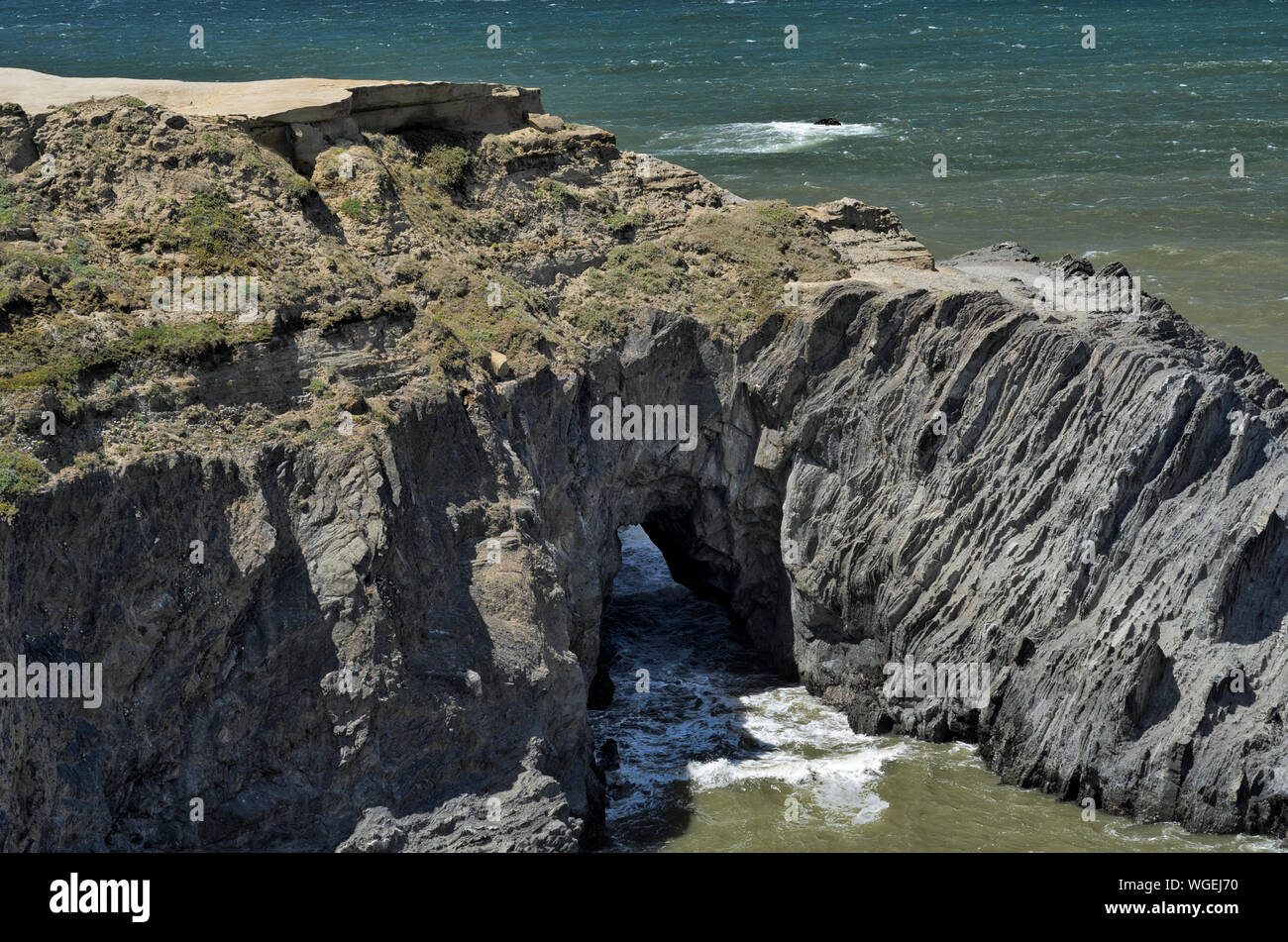 Otter Point, a natural bridge in Otter Point State Park near Gold Beach ...