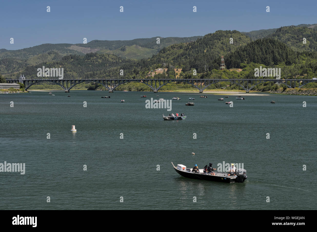 Fishermen crowd Gold Beach Harbor in Gold Beach, Oregon, with the US ...