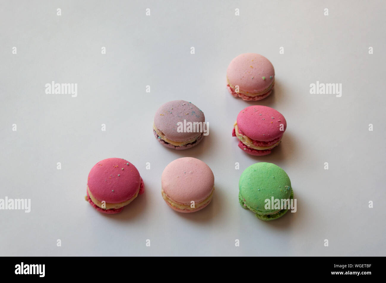 Colorful macaroon cakes triangle shaped composition isolated on white ...