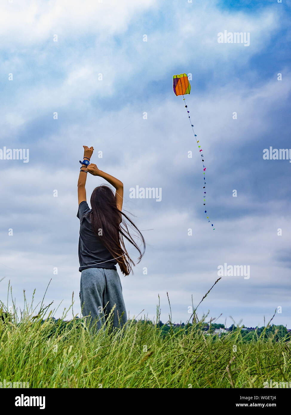 Woman flying kite hi-res stock photography and images - Alamy