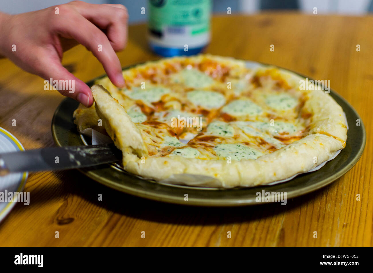Hand holding pizza slice hi-res stock photography and images - Alamy