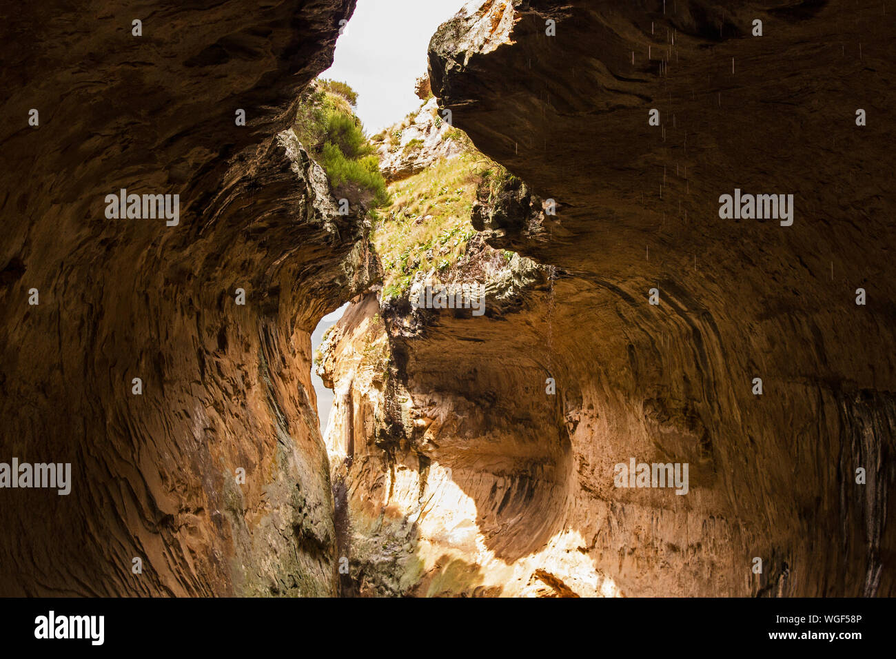 Within Eco ravine, a slot canyon, with sun coming through the top and ...