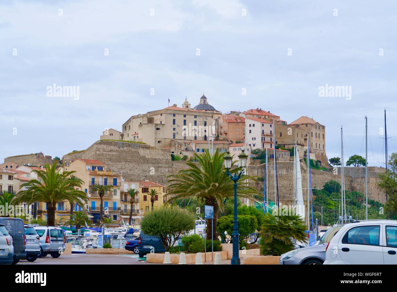 Old town of Calvi under a blue, light cloudy sky Stock Photo - Alamy