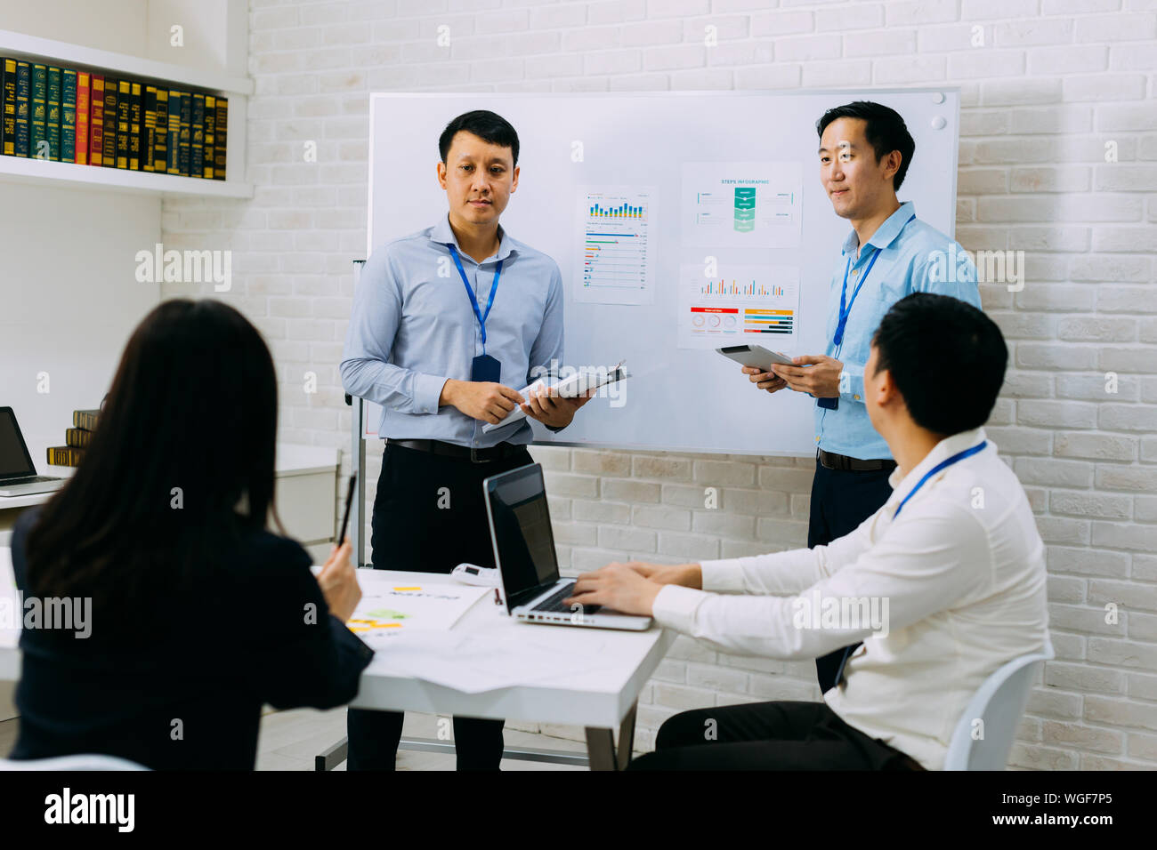 Young Asian business people having a discussion in meeting company room ...
