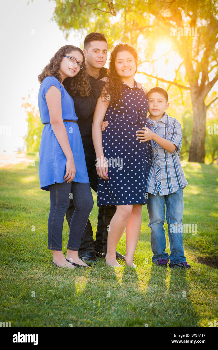 Hispanic Pregnant Family Portrait Outdoors Stock Photo - Alamy