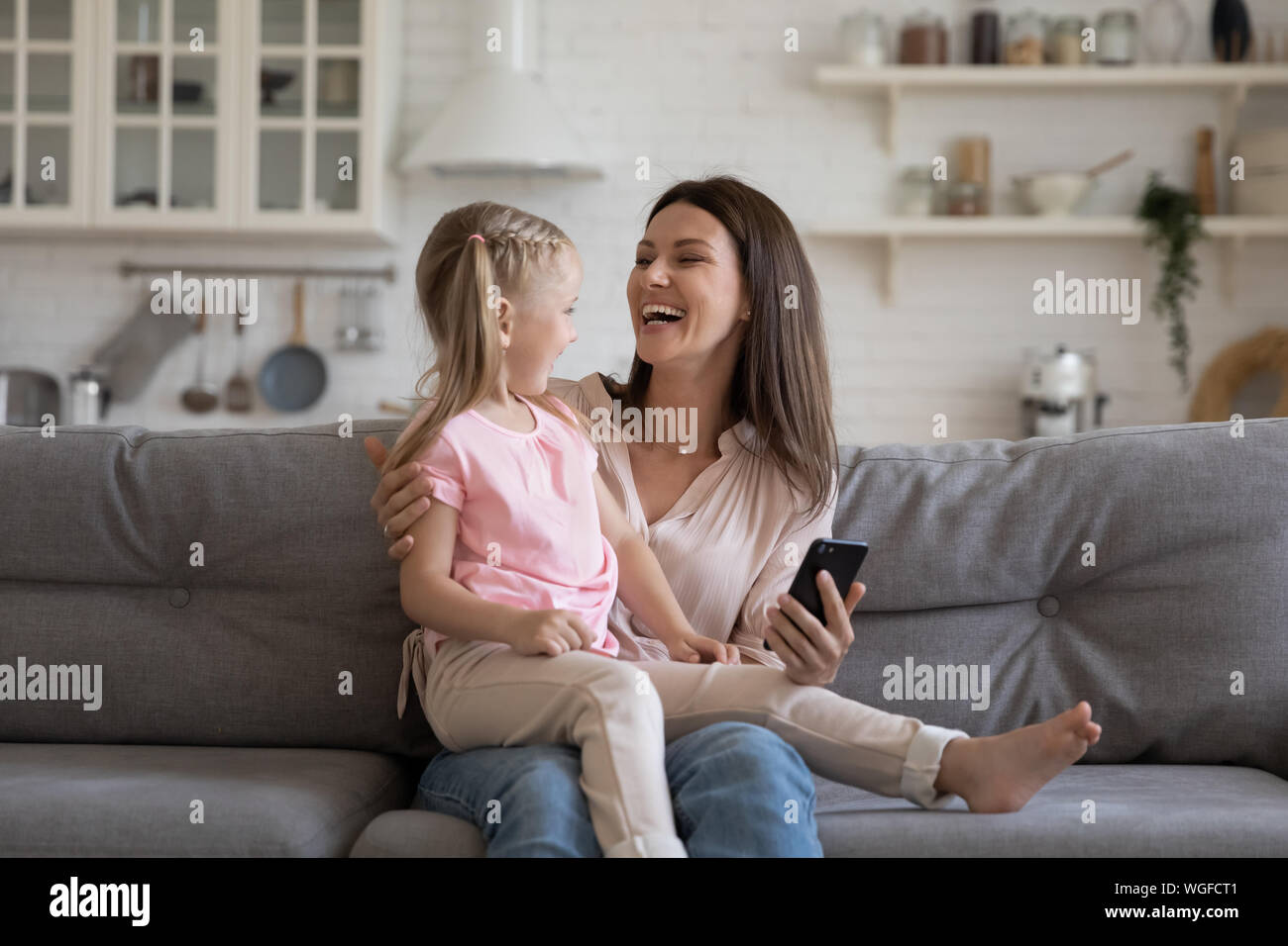Kid sitting on mom lap hi-res stock photography and images - Alamy