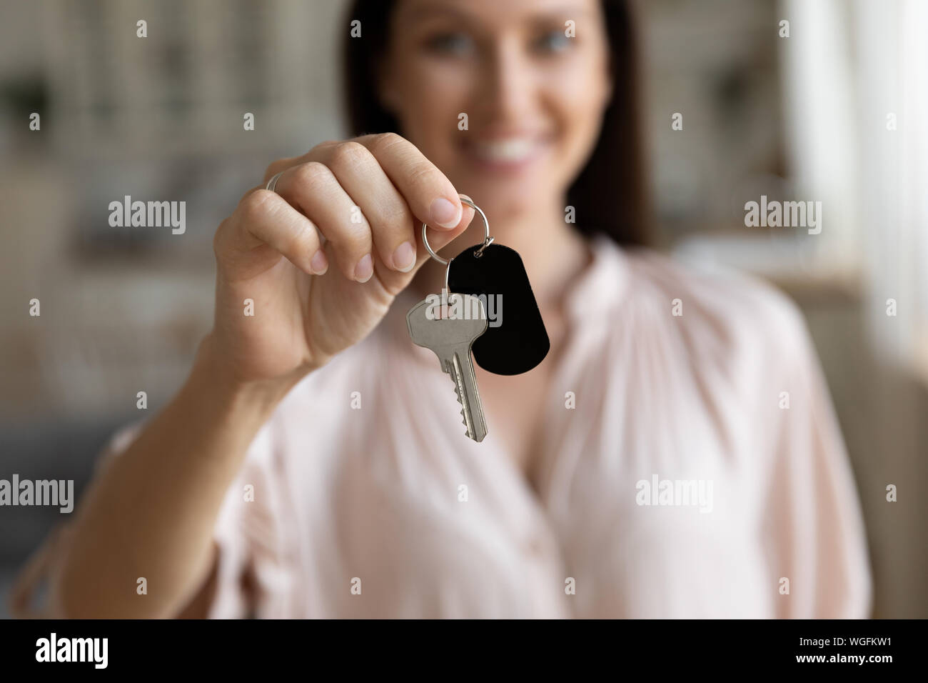 Close up focus on female hand holding key from house Stock Photo - Alamy