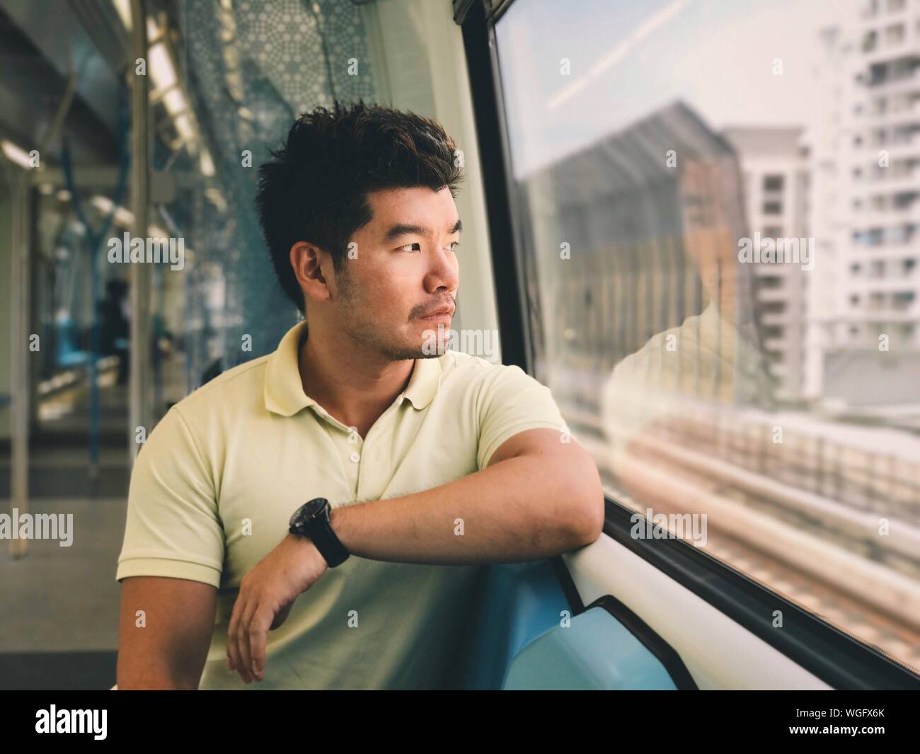 Man sitting on train hi-res stock photography and images - Alamy