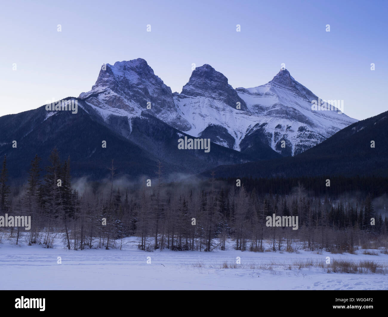 Sunset view of the Three Sisters from a frozen Policemen's Creek along ...