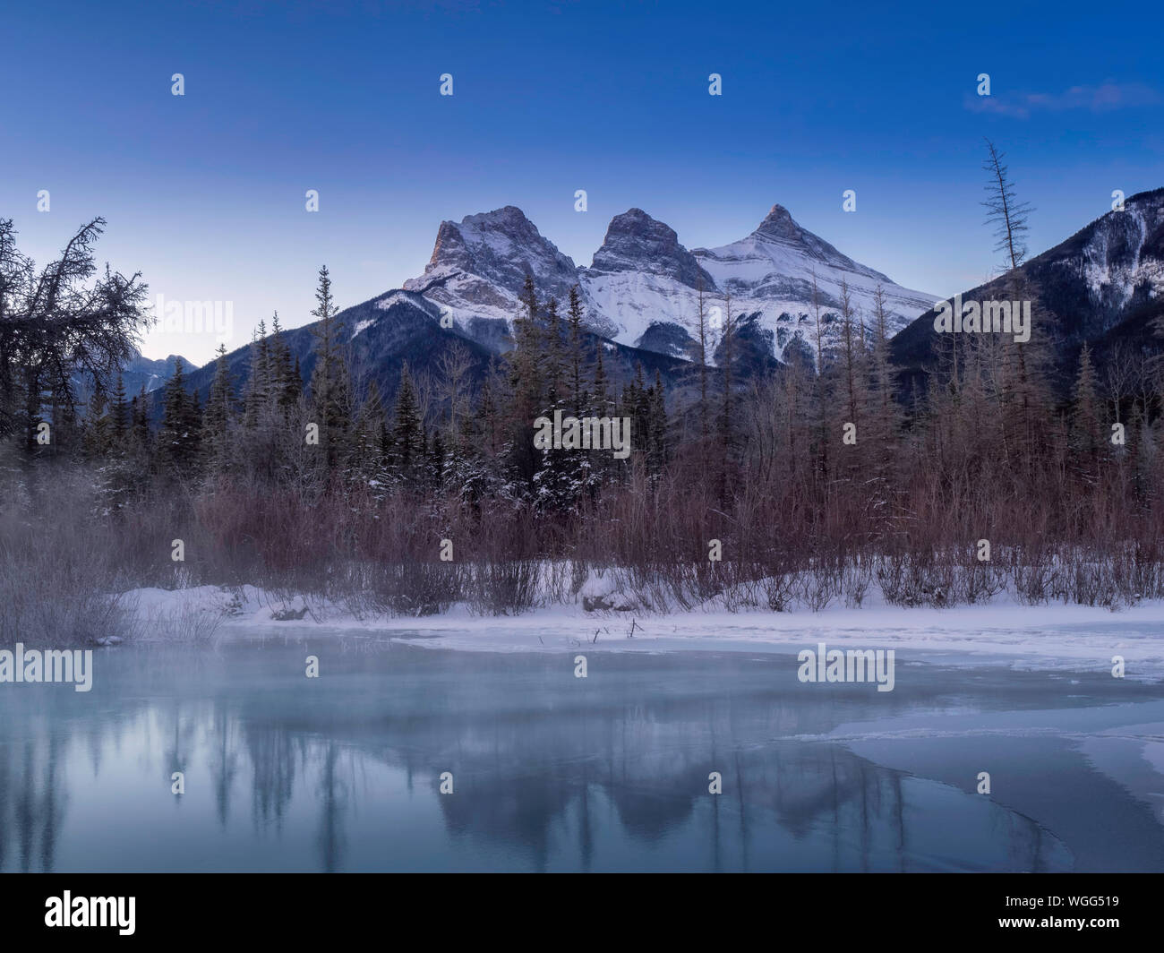 Sunset view of the Three Sisters from a frozen Policemen's Creek along ...