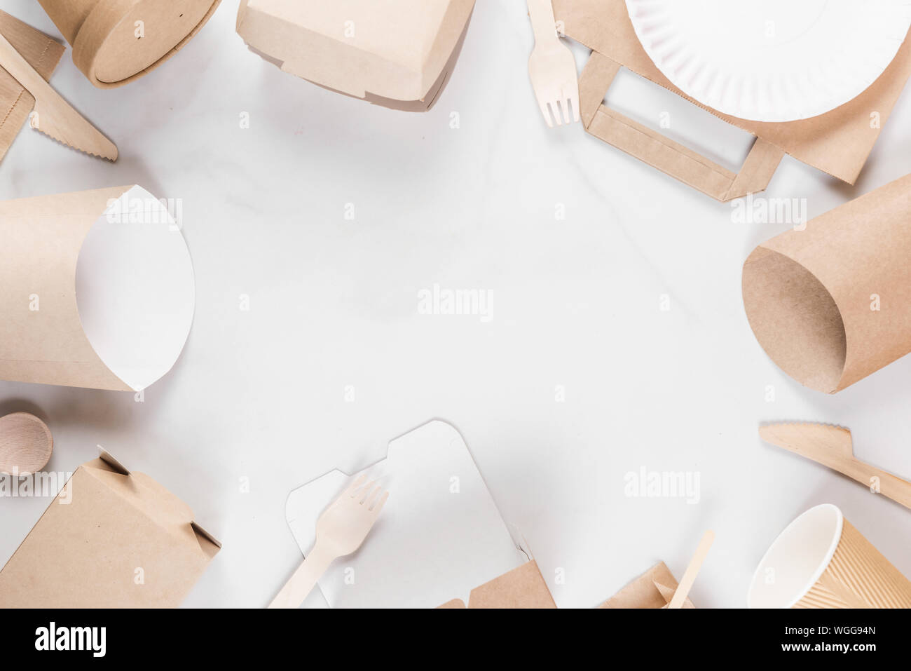 Frame made of eco friendly disposable tableware. Paper cups, dishes ...