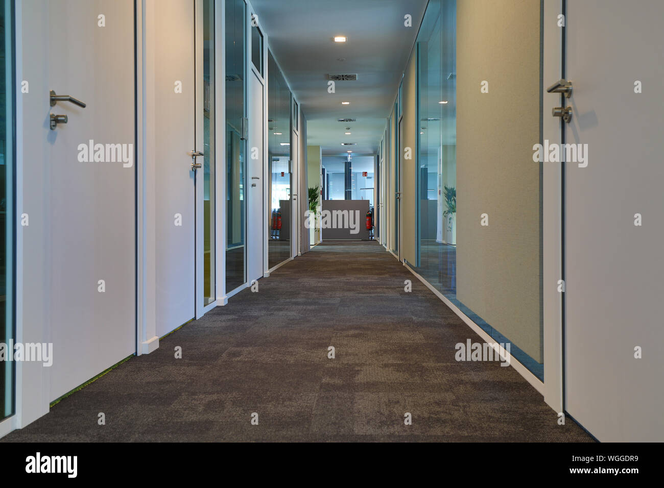 on a modern office floor a corridor leads to the offices Stock Photo ...