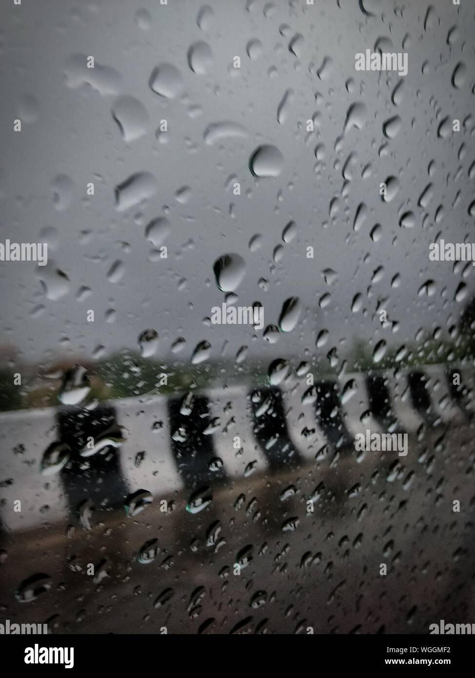 Divider On Road Seen Through Wet Window Of Car During Monsoon Stock ...