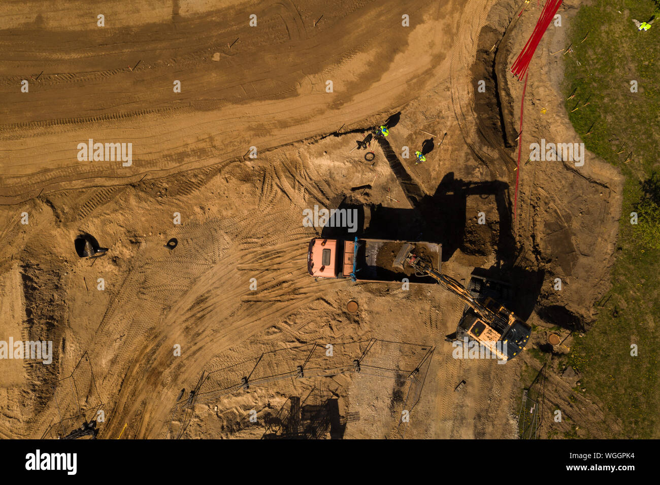 Drone top down view of construction site and excavator excavating soil ...