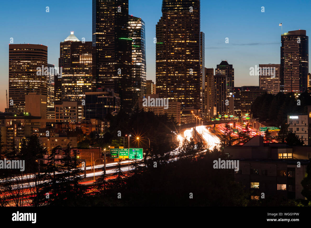 Seattle skyline sunset with city lights and car traffic on I-5 Stock ...