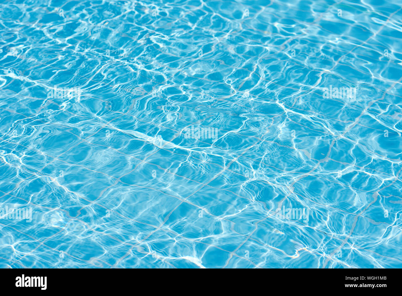Background of water in blue swimming pool, water surface with sun ...